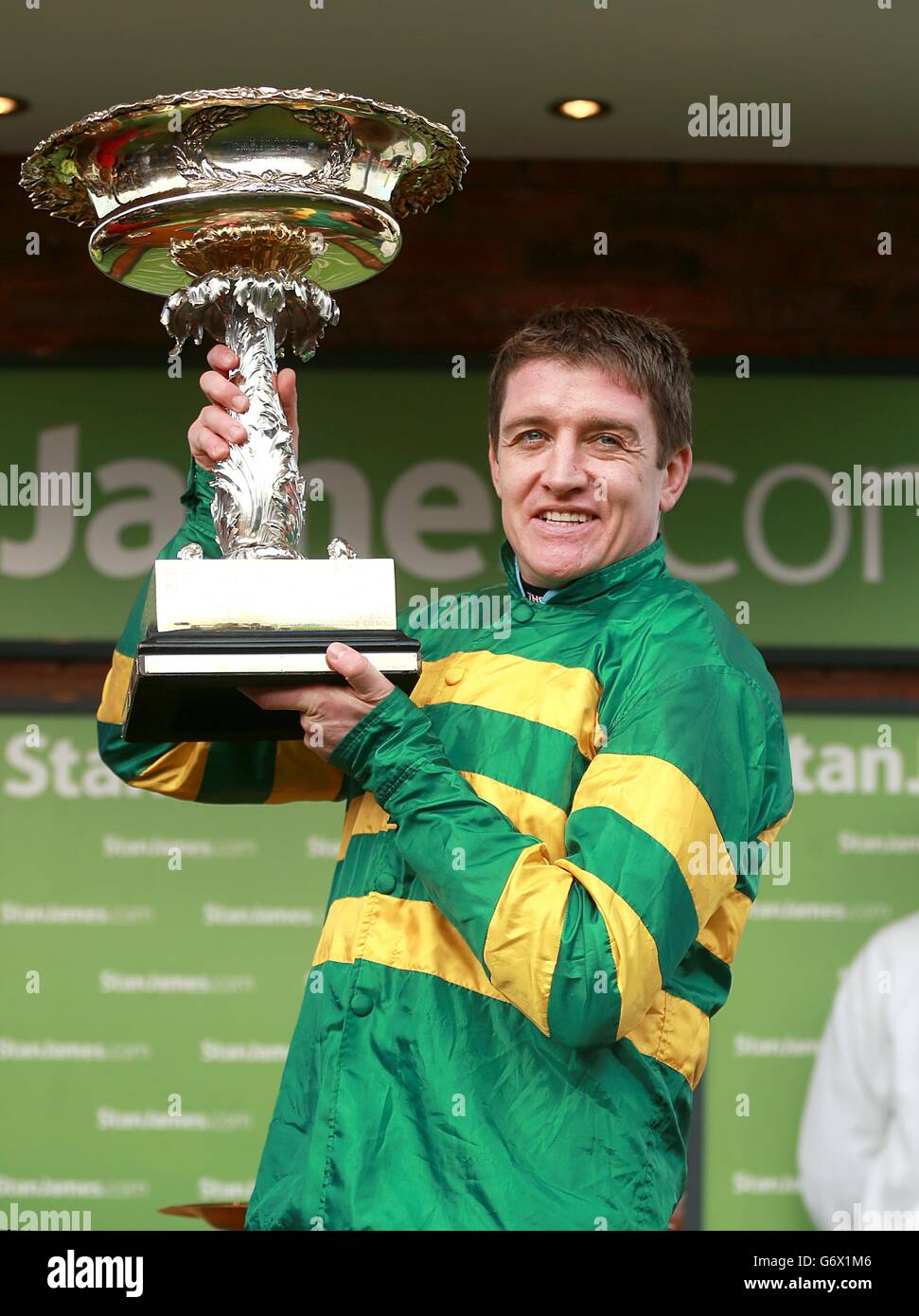 Jockey Barry Geraghty poses with the trophy after victory on board ...