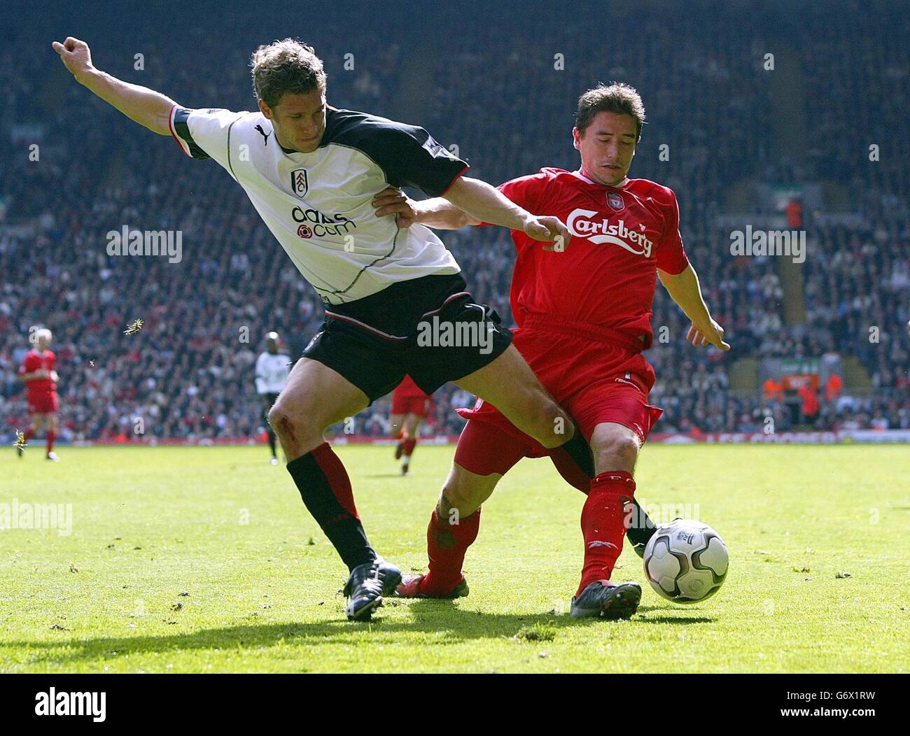 Liverpool's Harry Kewell (right) battles with Moritz Volz of Fulham ...
