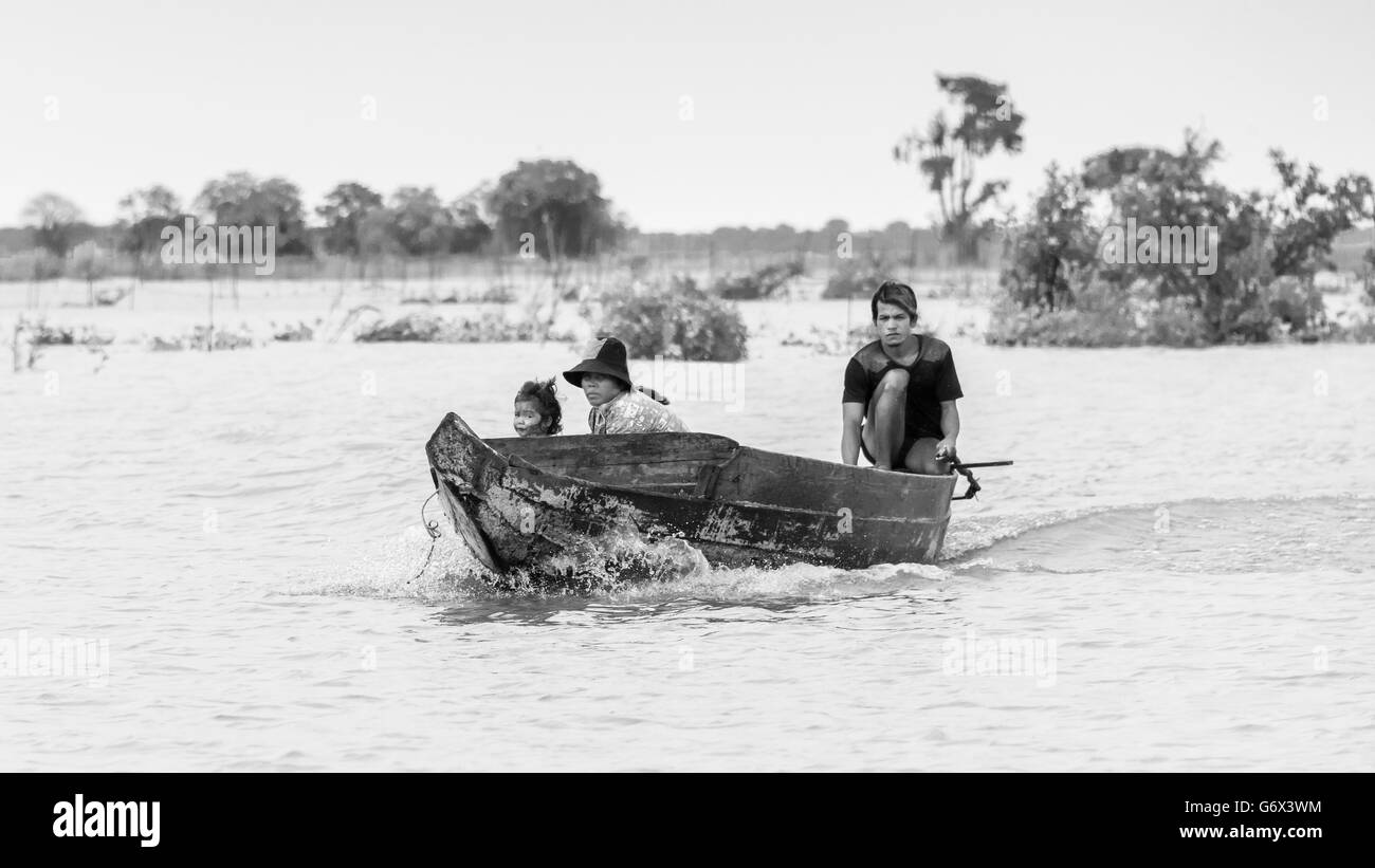 Family in boat during monsoon season on Tonle Sap, Cambodia Stock Photo ...