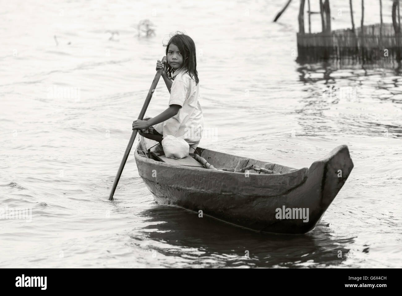 Girl poling a dugout canoe BW, Tahas River, Kampong Phluck, Cambodia ...