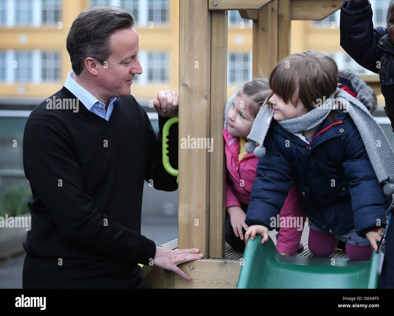 Children look at Prime Minister David Cameron during a visit to the ...