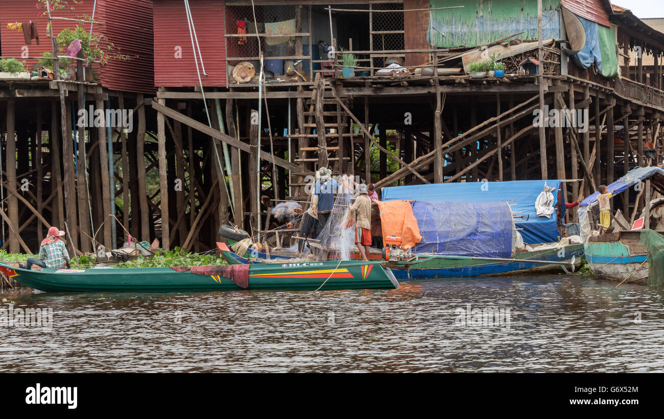 Inspecting the nets, Kampong Phluck village, stilt houses, Tahas River ...