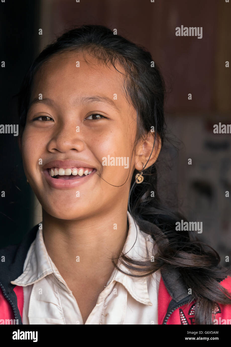 Laughing school girl in a doorway, Kampong Phluck, Cambodia Stock Photo ...