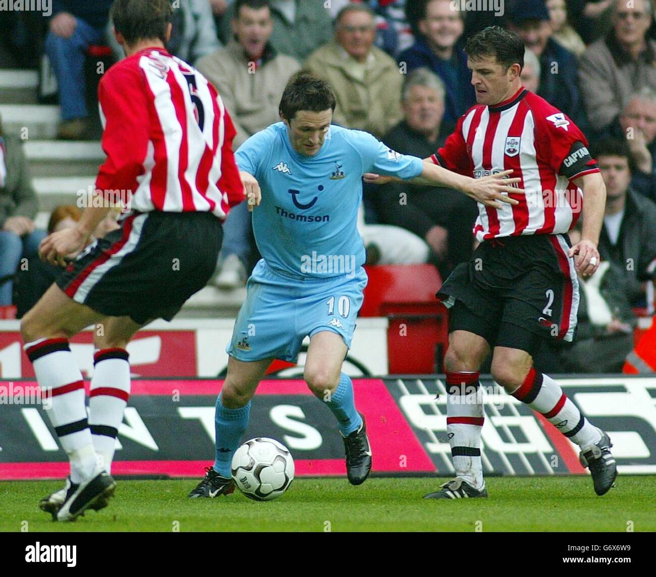 Robbie Keane of Tottenham Hotspur (centre) slips between Southampton's ...