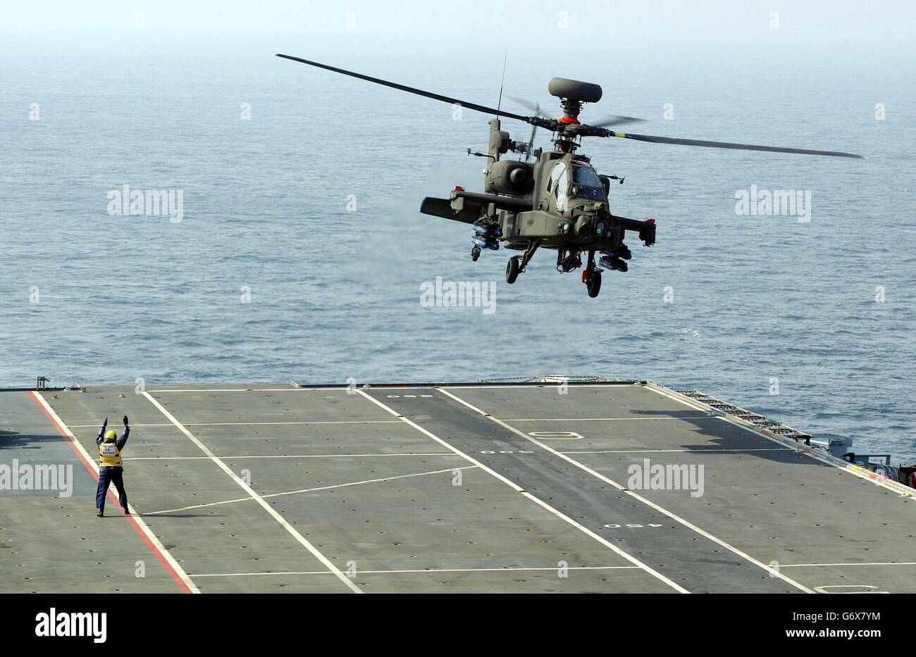 An Apache attack helicopter takes off from HMS Ocean in the Bristol ...