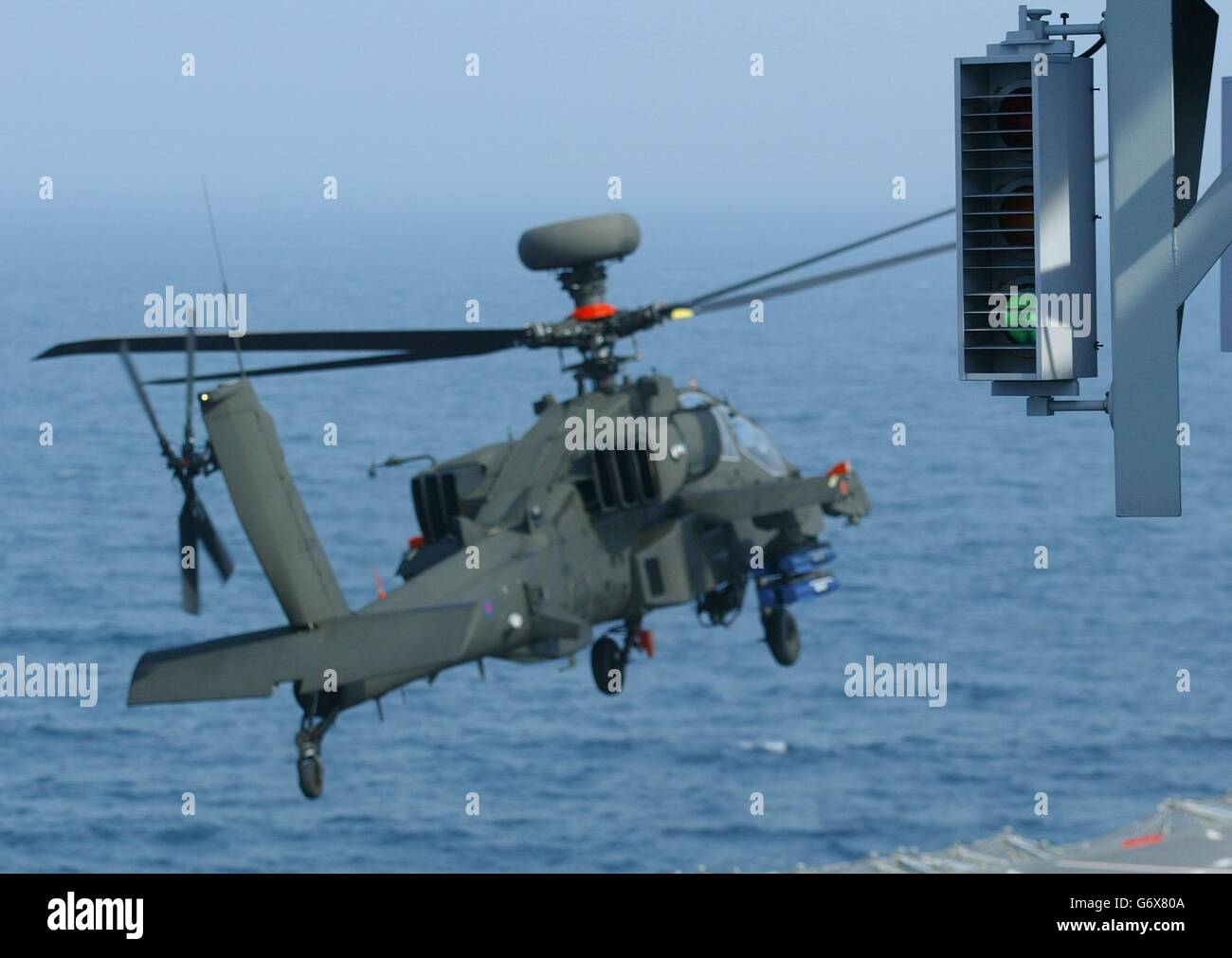 An Apache attack helicopter gets the green light to take off from HMS ...