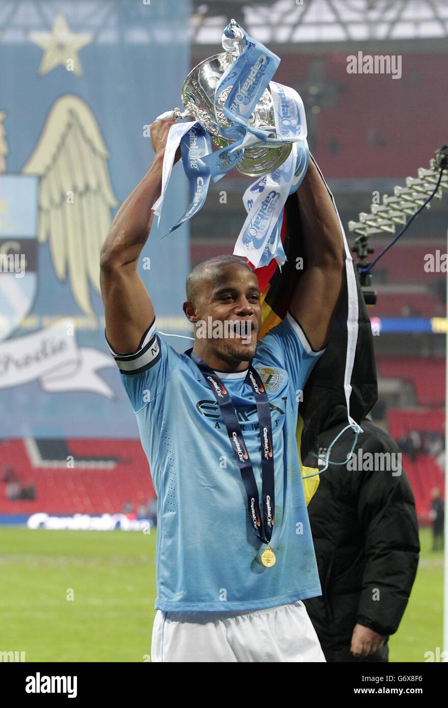 Manchester City captain Vincent Kompany celebrates with the trophy ...