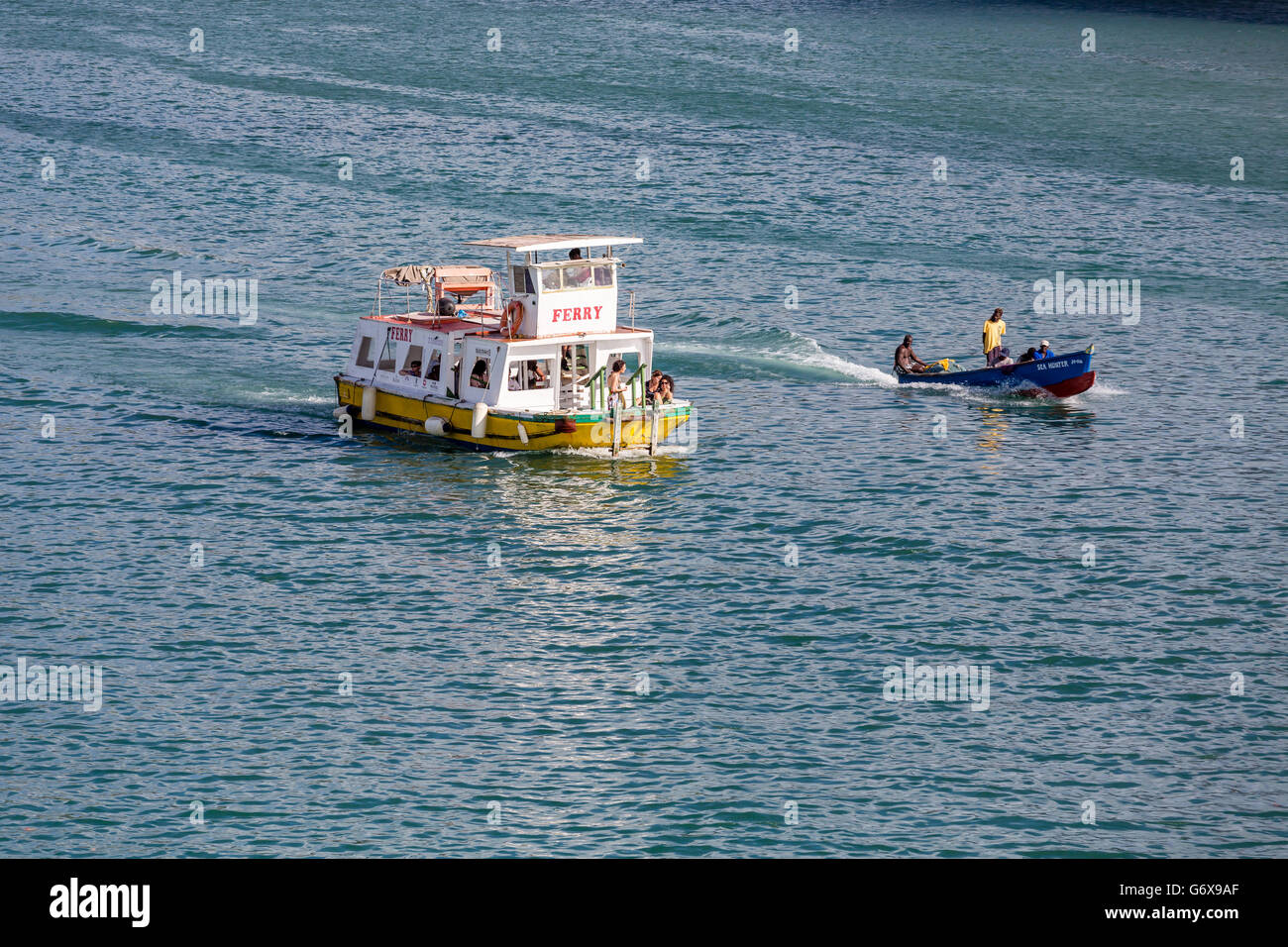 Fishing Boat Passing Ferry in St Lucia Stock Photo - Alamy