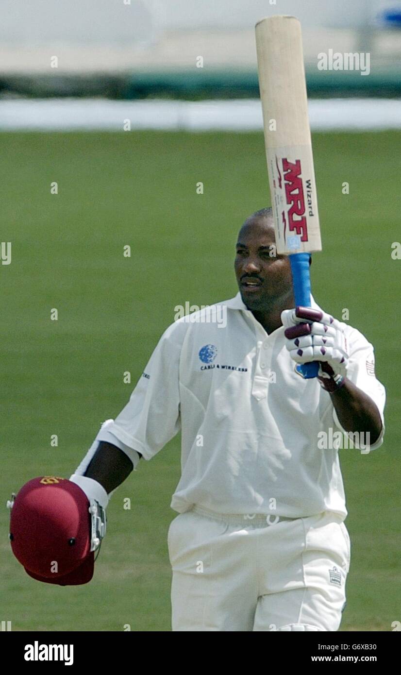 West Indian captain Brian Lara raises his bat after scoring a century ...