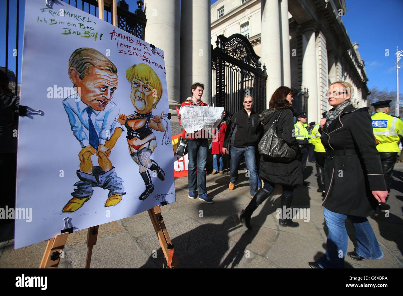 A Caricature by artist Ray Sherlock is displayed as protestors await ...
