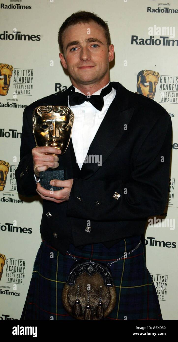 Showbiz tvbafta04 celebrity journalist trophy kilt tvbaftagal mark daly hi-res stock photography ...