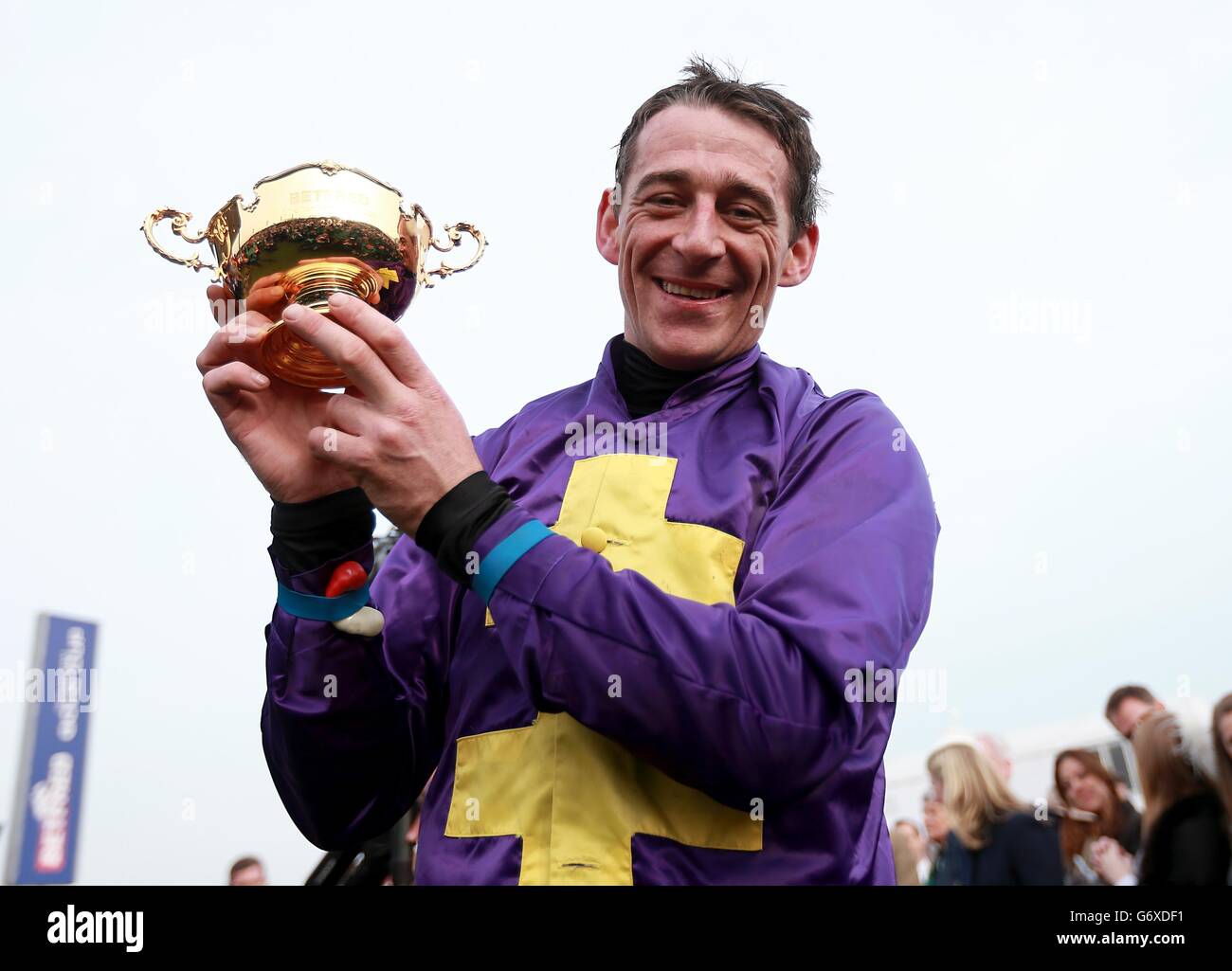 Jockey Davy Russell celebrates with the Gold Cup trophy after winning ...