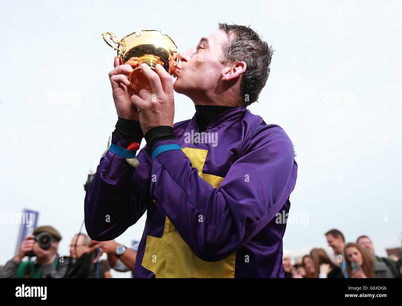 Jockey Davy Russell celebrates with the Gold Cup trophy after winning ...