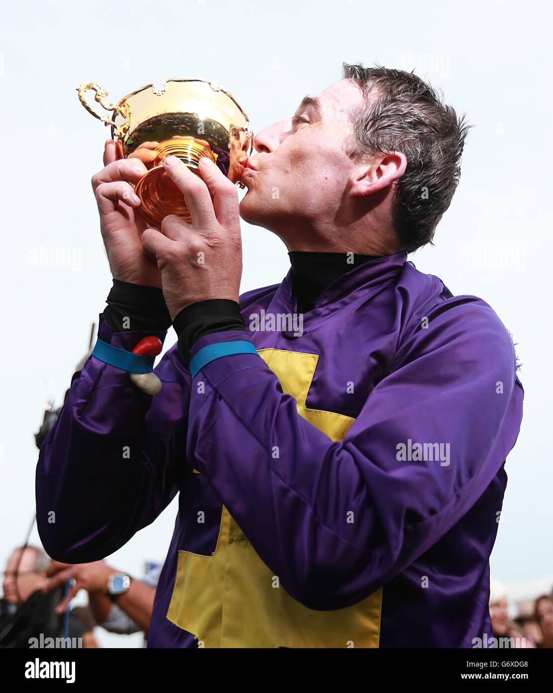 Jockey Davy Russell celebrates with the Gold Cup trophy after winning ...