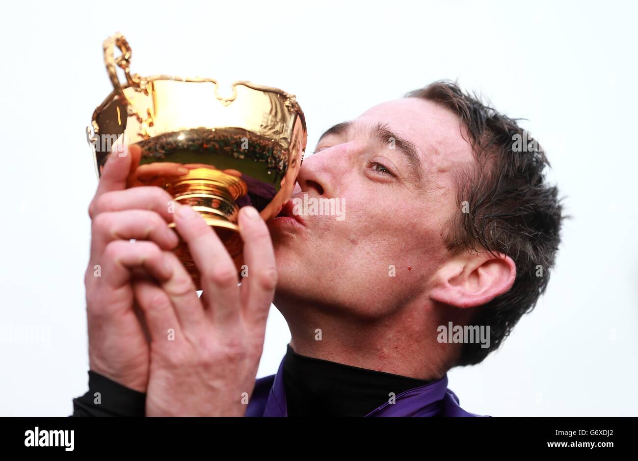 Jockey Davy Russell celebrates with the Gold Cup trophy after winning ...