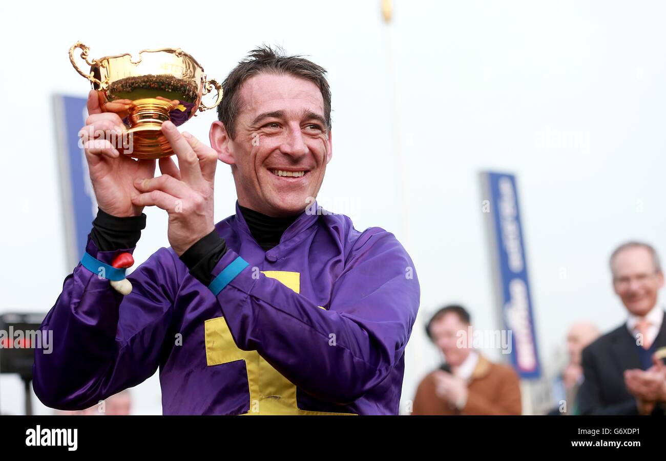 Jockey Davy Russell celebrates with the Gold Cup trophy after winning ...