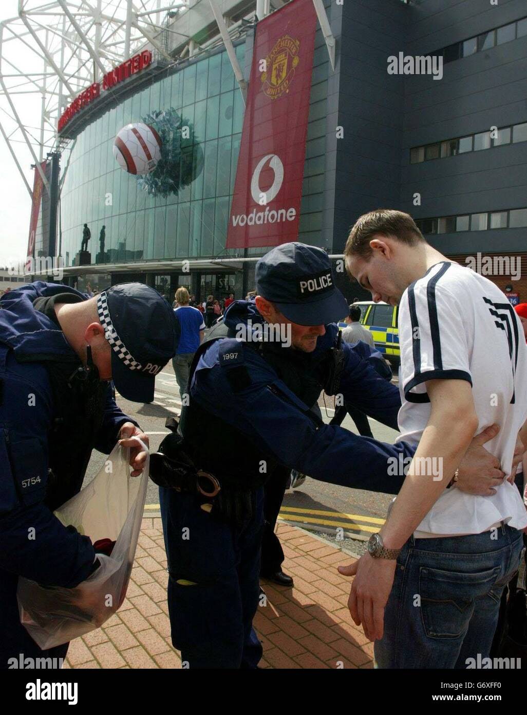 Old Trafford security. Police officers search fans ahead of the ...