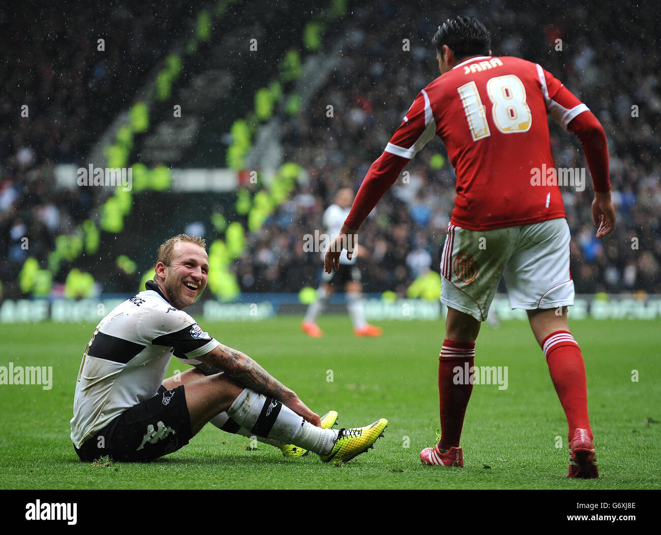 Derby County's Johnny Russell (left) gets a hand from Nottingham Forest ...