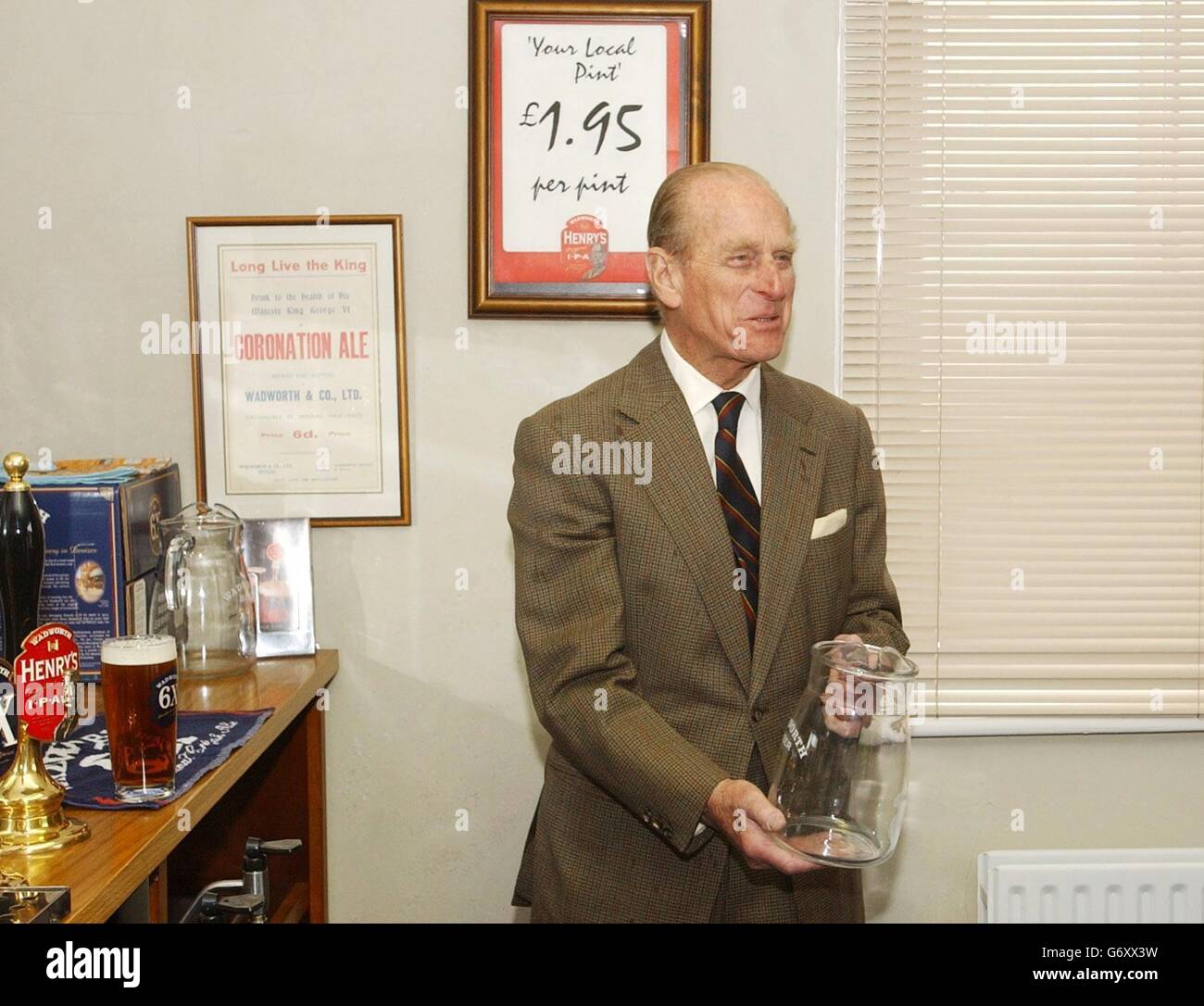 The Duke of Edinburgh holds up a four pint jug after pulling a pint at ...