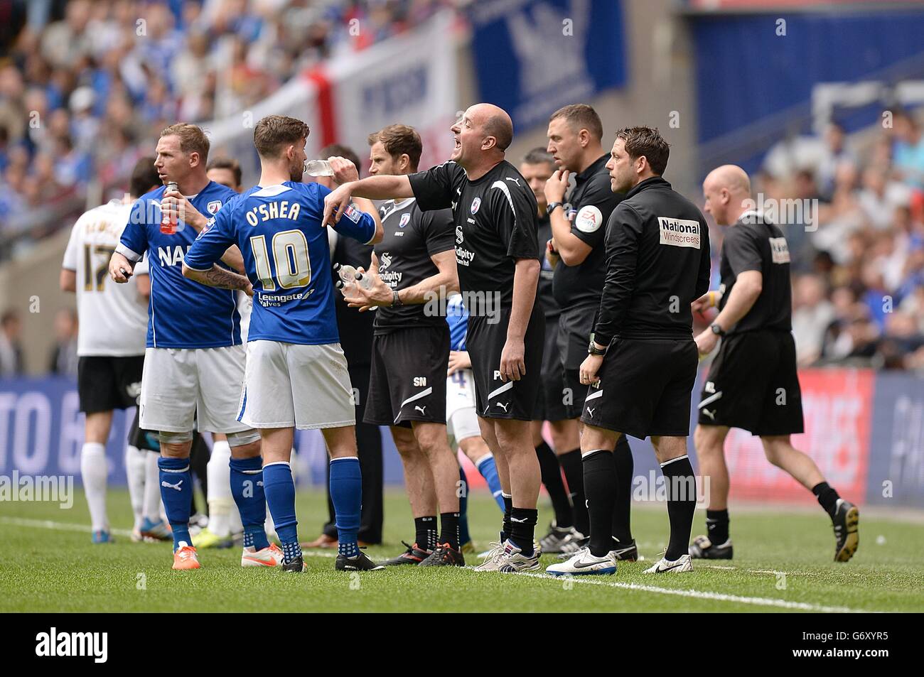 Chesterfield manager Paul Cook re-organises his team during a break in ...