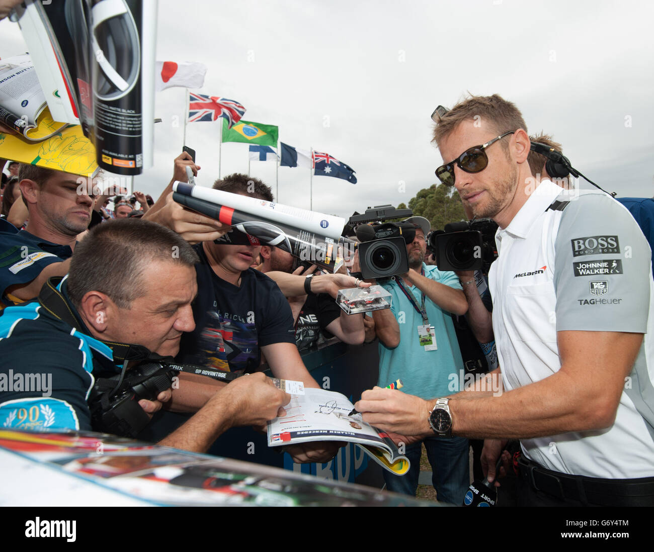 Great Britain's Jenson Button of McLaren Mercedes signs autographs ...