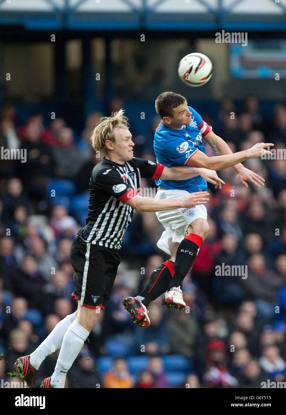Rangers' Lee McCulloch (right) leaps for the ball against Dunfermline's ...
