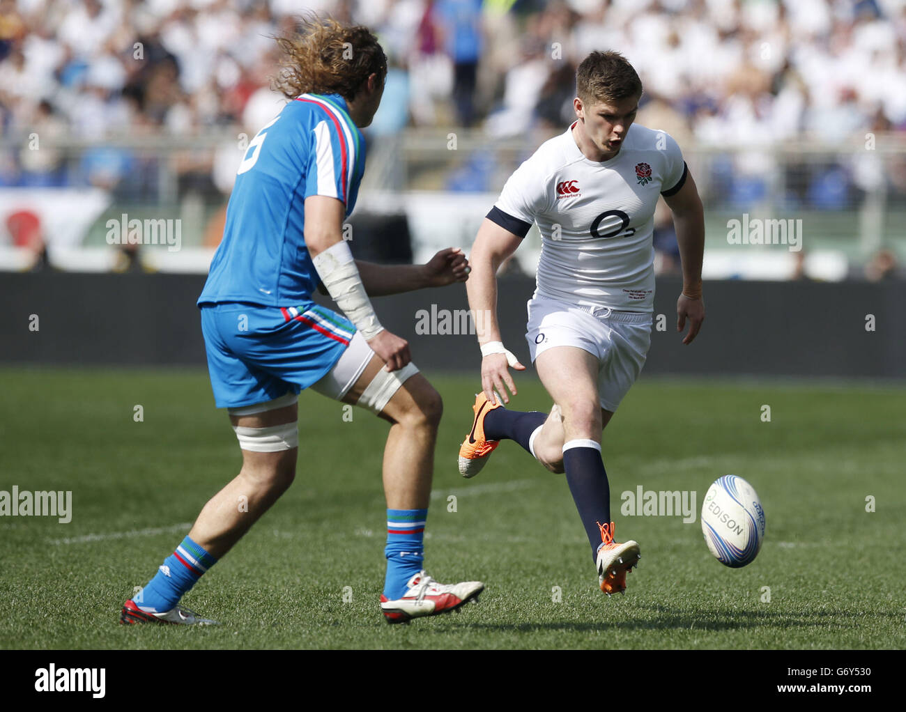 England's Owen Farrell (right) places a kick along the ground past ...