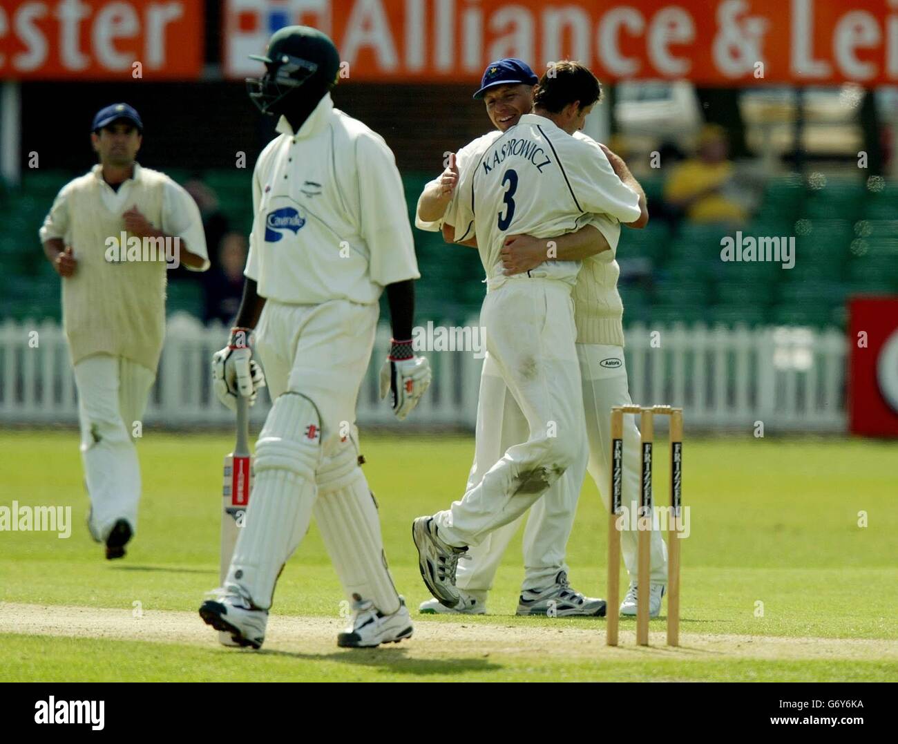 Michael Kasprowicz (No.3) is hugged by team mate Alex Wharf after ...
