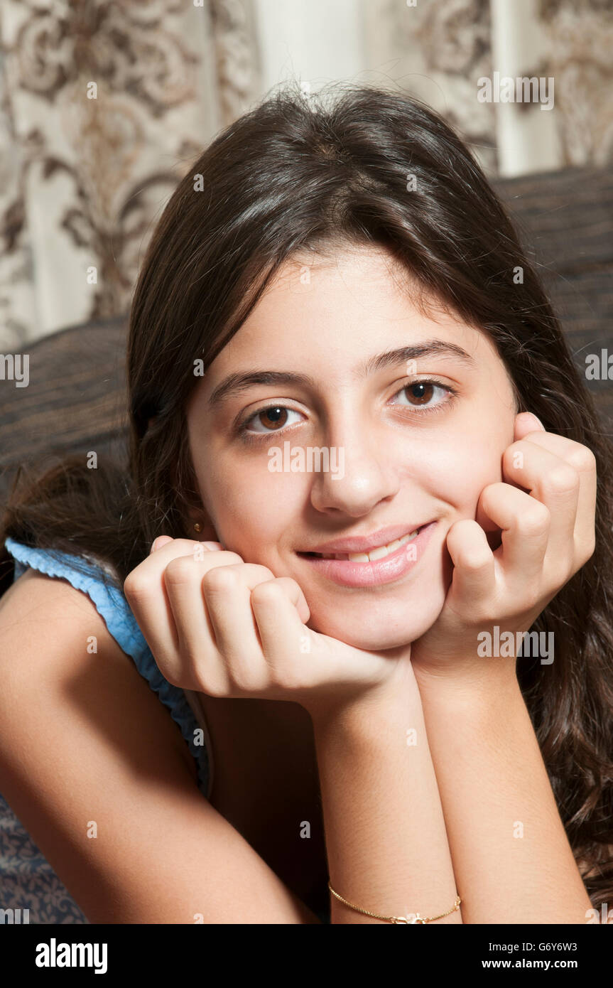 Happy girl leaning on hands smiling Stock Photo - Alamy