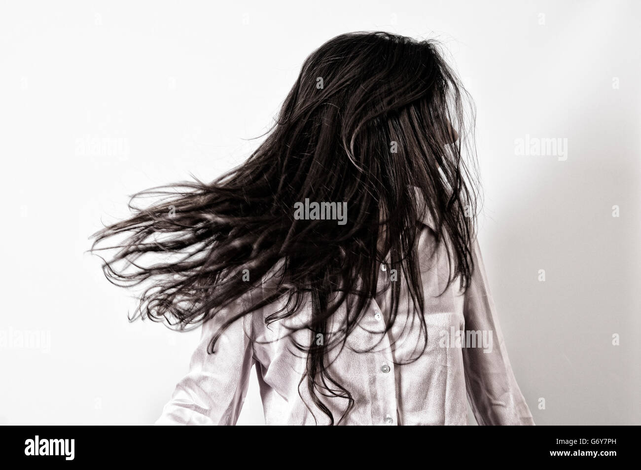 Young woman flicking hair Stock Photo - Alamy
