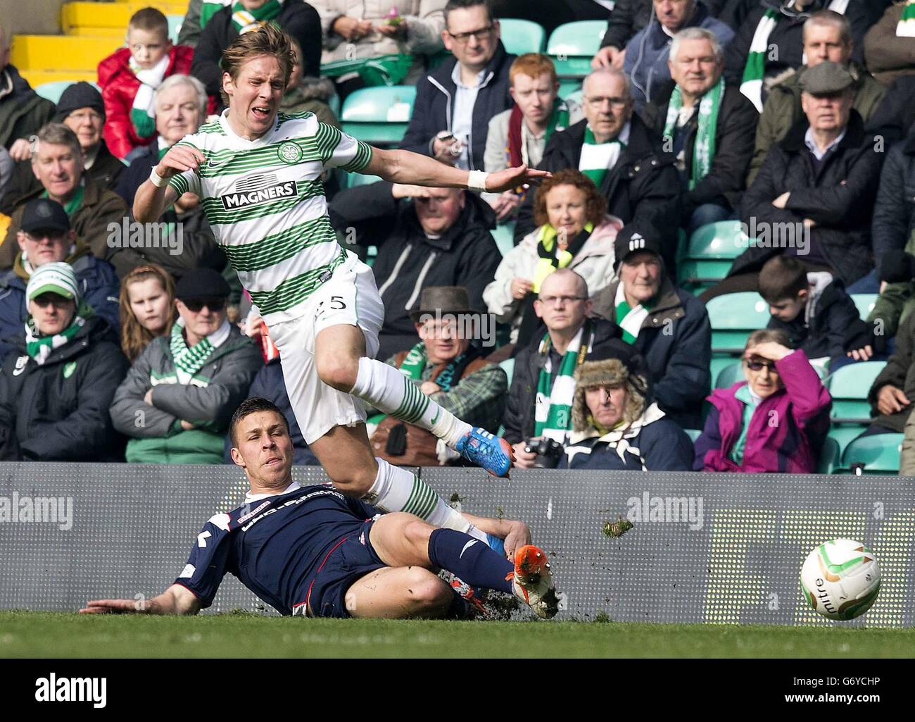 Ross County's Filip Kiss slides into Celtic's Stefan Johansen (right ...