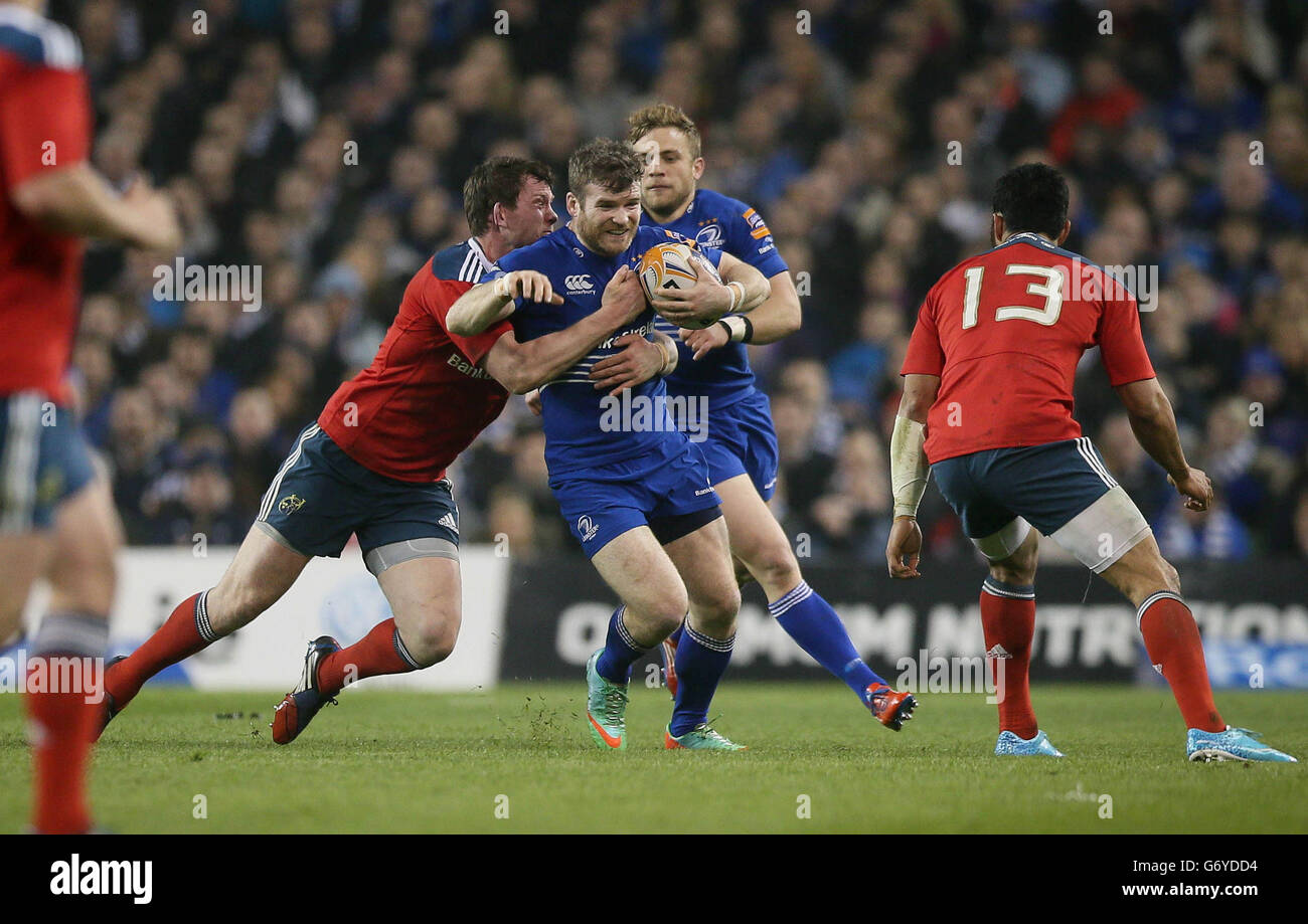 Leinster's Gordon D'Arcy is tackled by Munster's Denis Hurley during ...