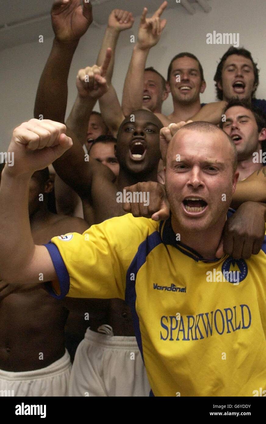 Torquay Captain Craig Taylor (centre right) leads the celebrations ...