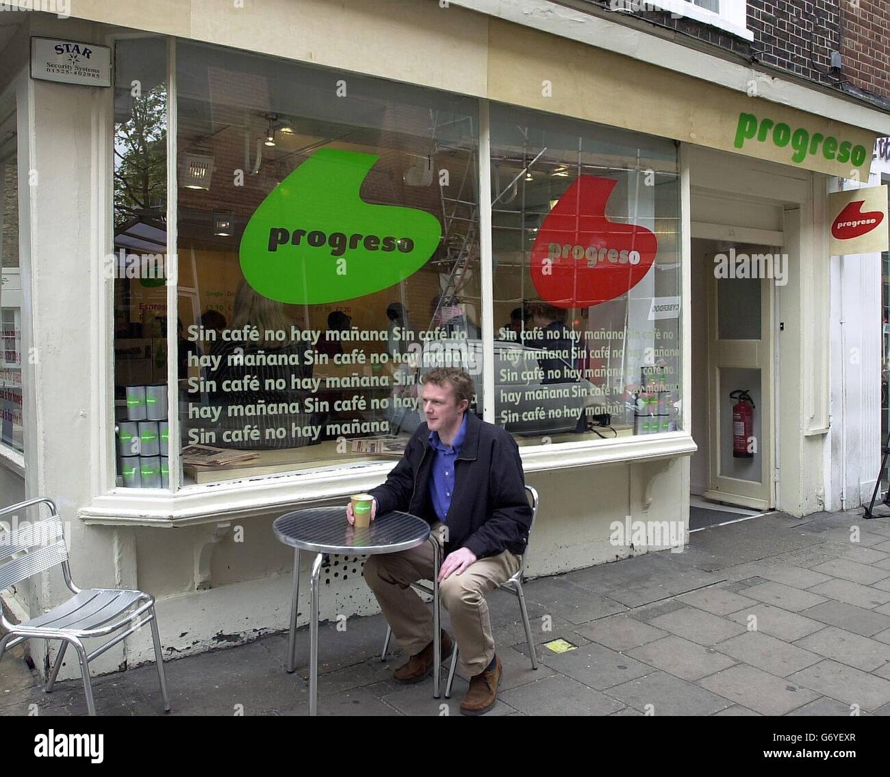 A customer enjoys a coffee at Progreso, a fair trade coffee shop ...