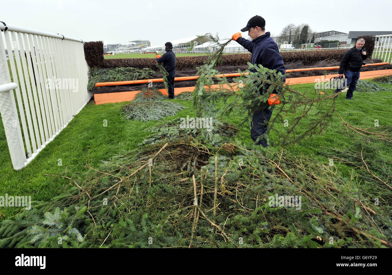 Fence builders complete the dressing of a fence on the Mildmay Courses ...