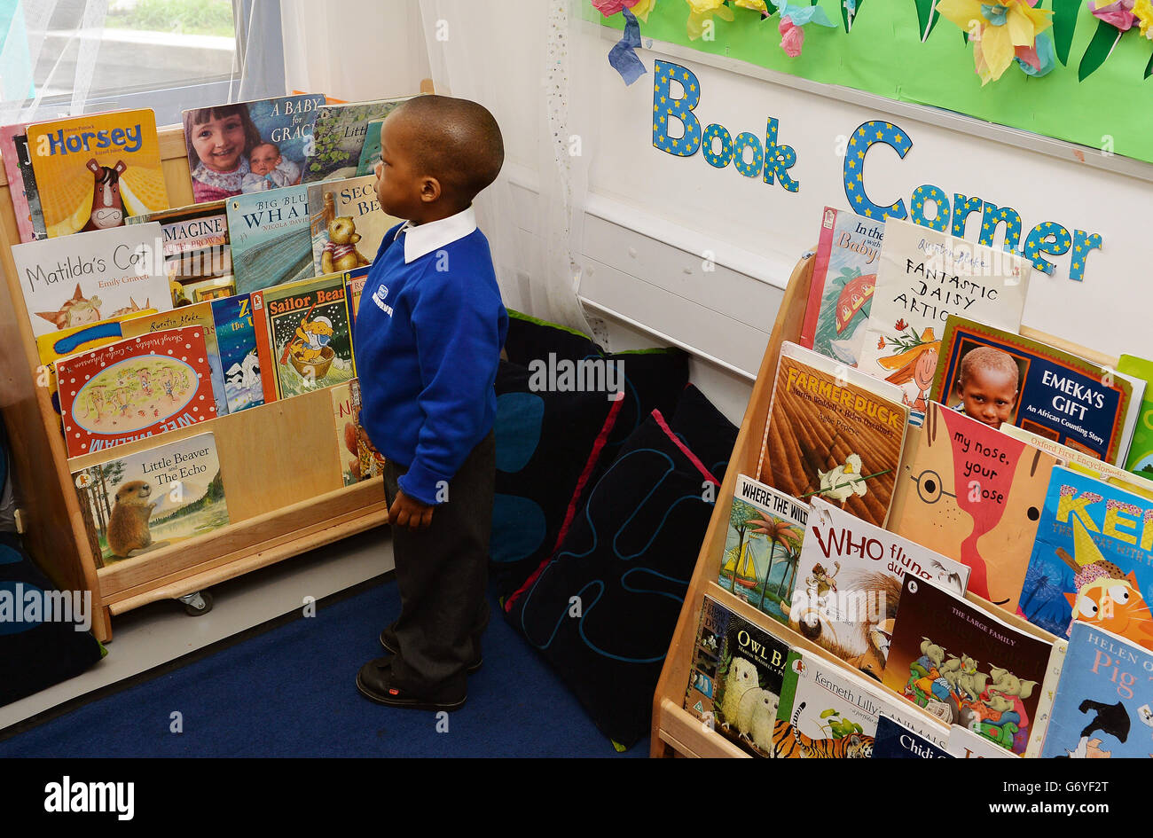 A child looking at books at the Windrush Nursery in Greenwich, south ...
