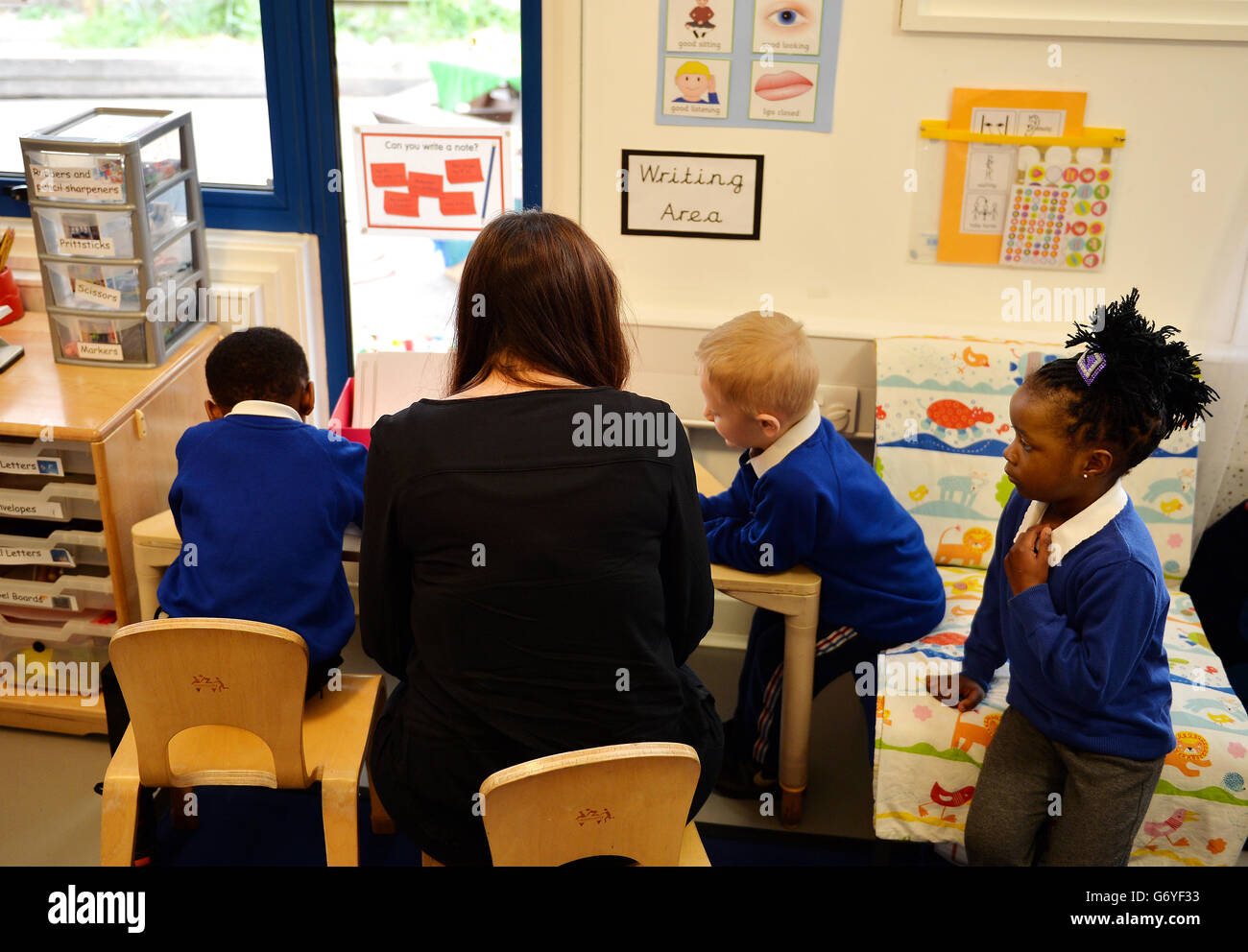 Children and a teacher at the Windrush Nursery in Greenwich, south east ...