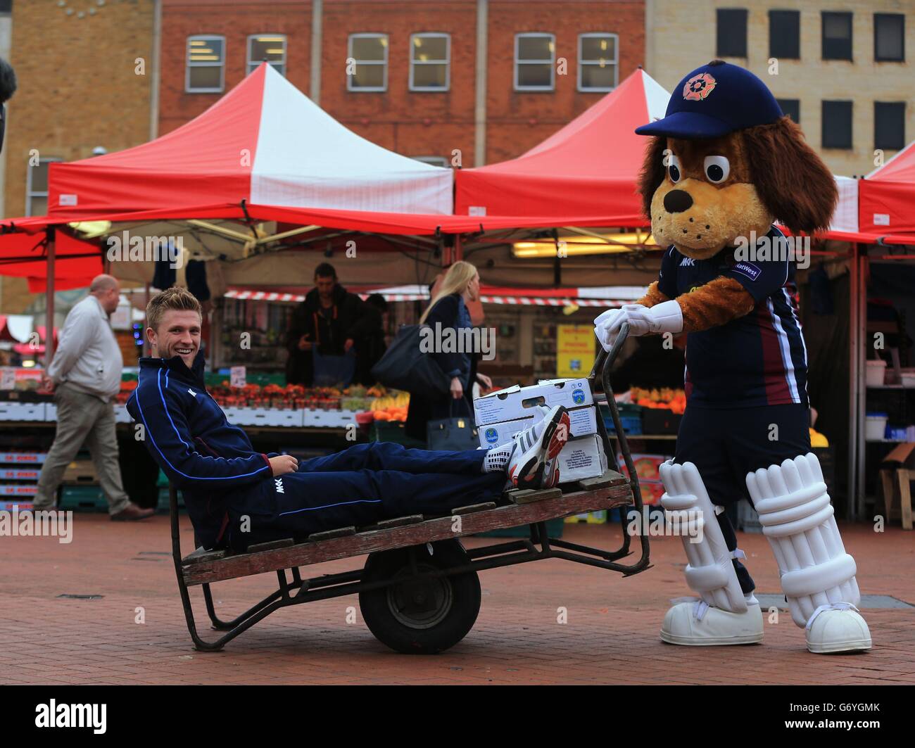 Northamptonshire's David Willey sits in a market barrow in Market ...