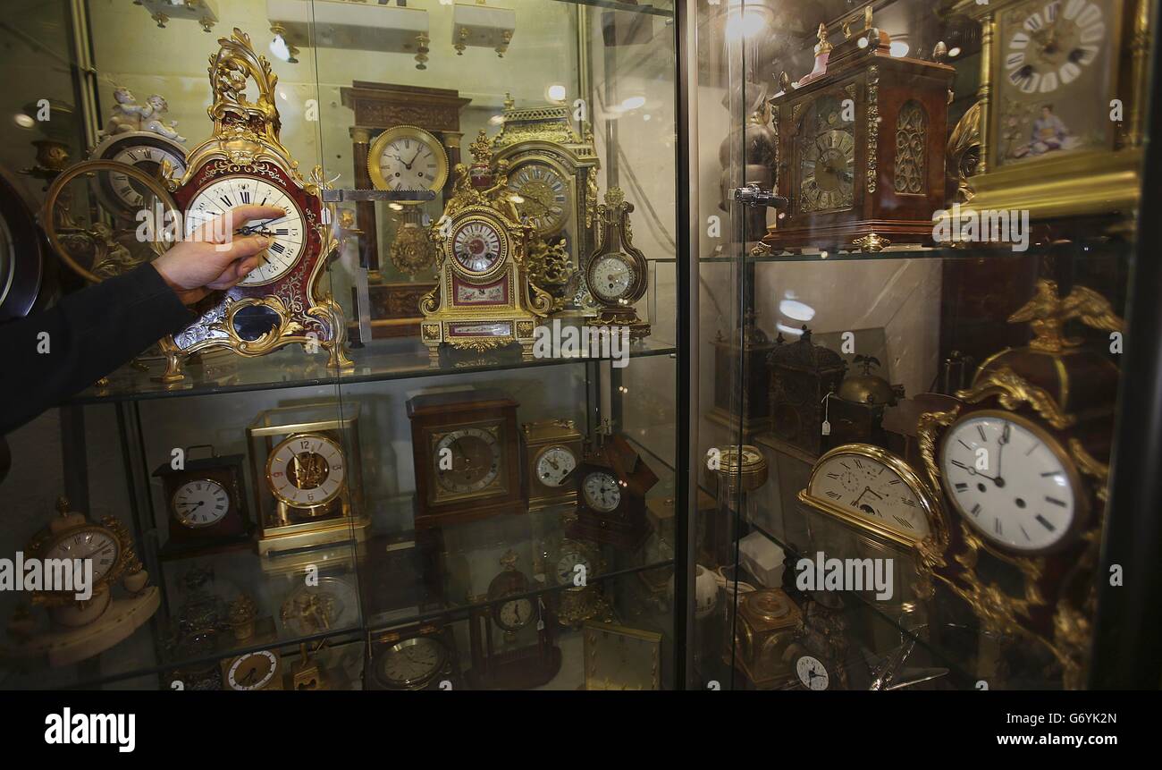Nick Tarrant adjusts a 1850 bronze and gilt clock at the London Antique ...