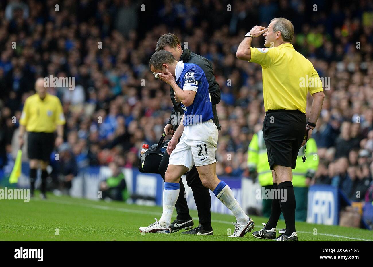 Referee Martin Atkinson (right) gestures as Everton's Leon Osman ...