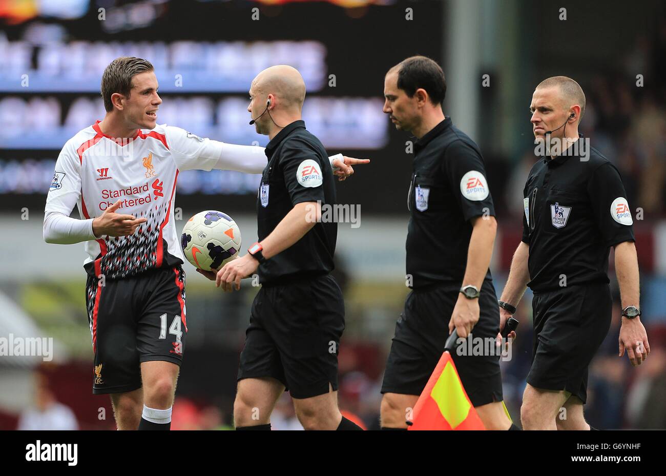 Liverpool's Jordan Henderson (left) speaks with match referee Anthony ...