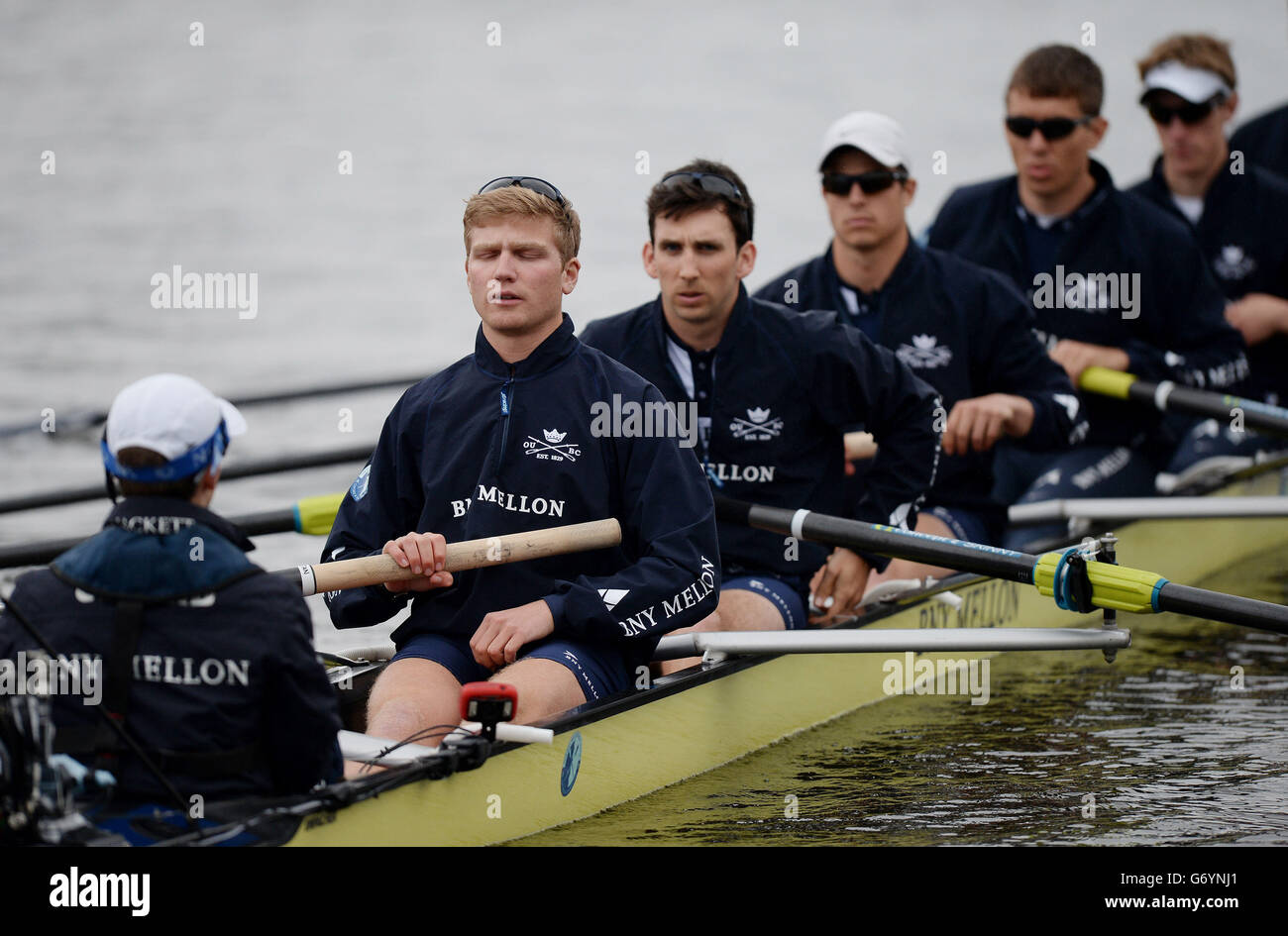 Oxford rowers prepare themselves as they leave the river bank before ...