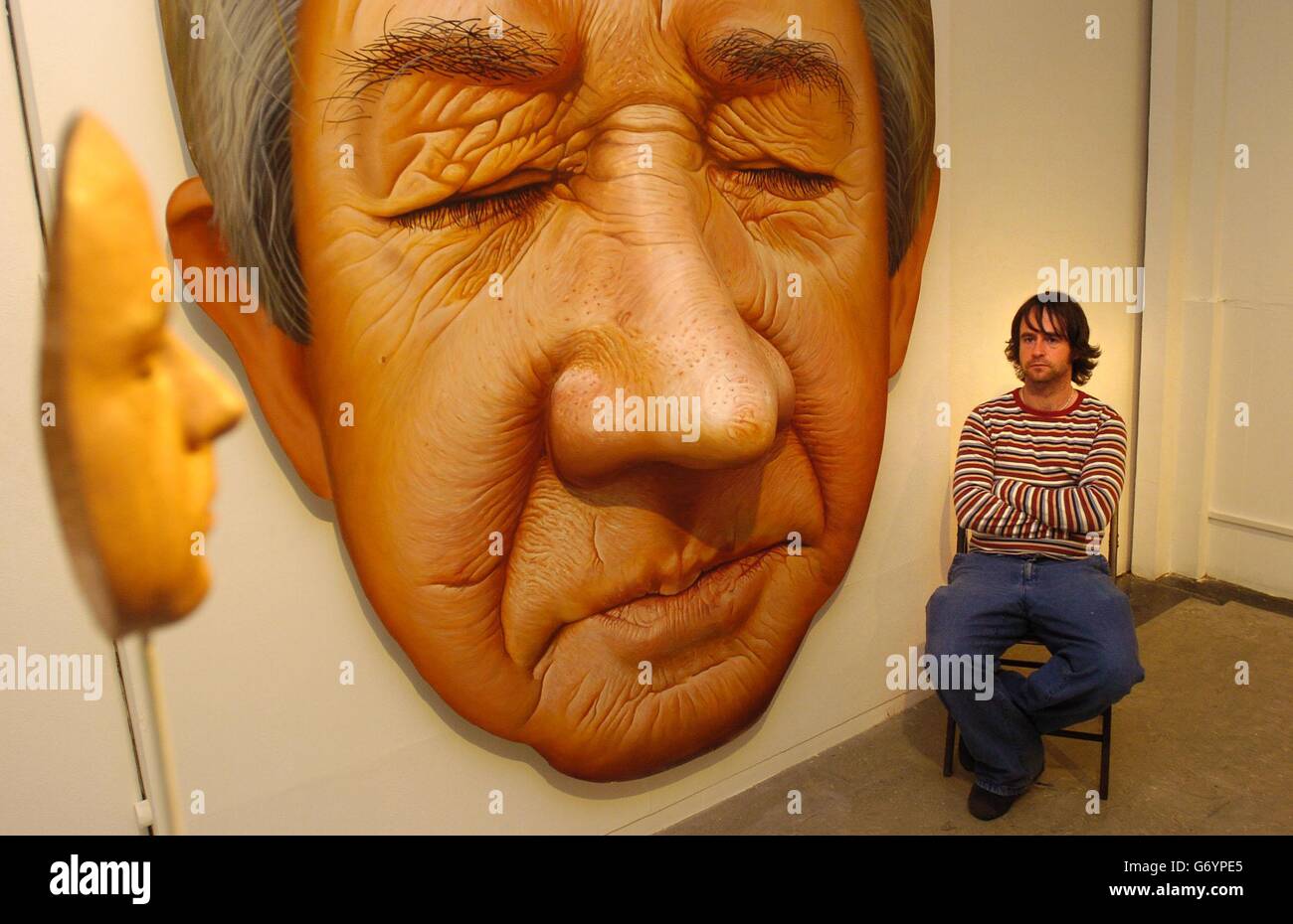 Student Simon Reekie with a mask of his face(left) and painting of his ...