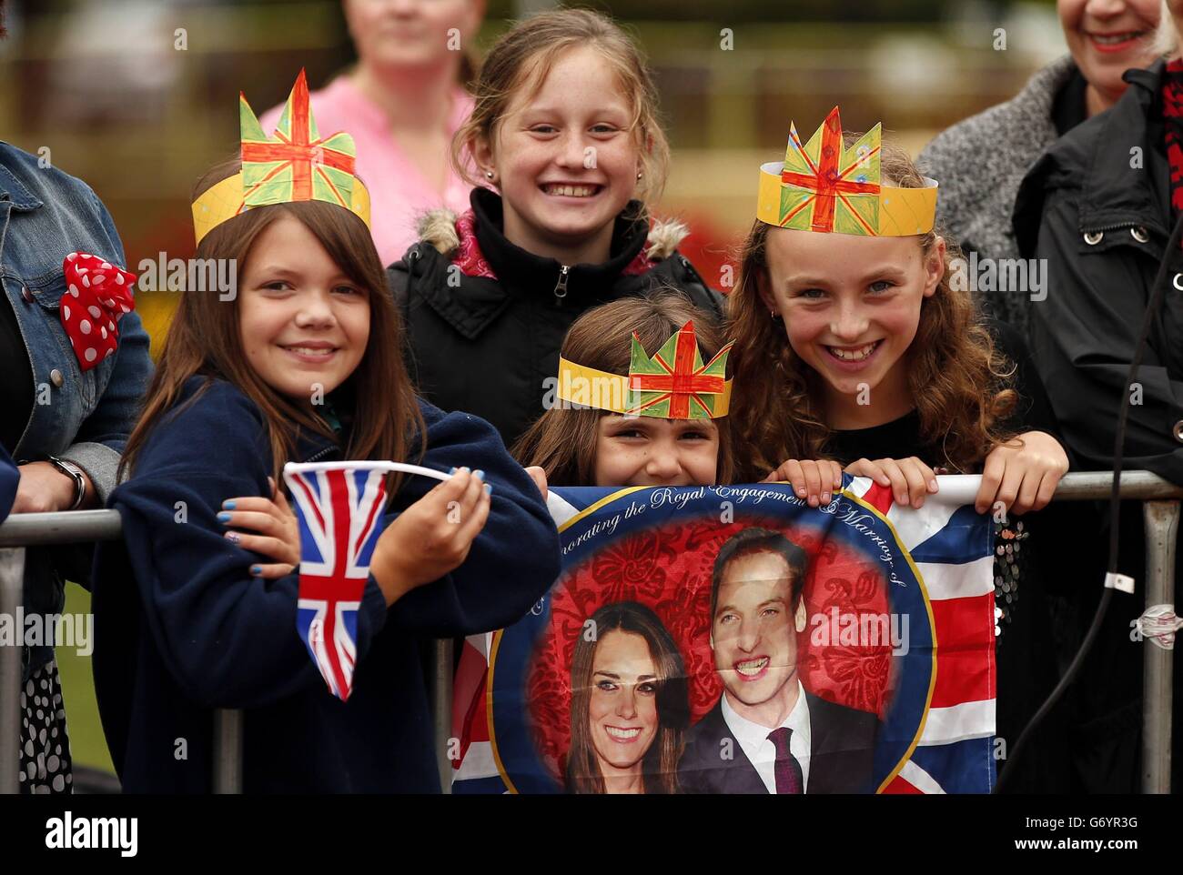Children wearing crowns made from cardboard wait for the Duke and ...