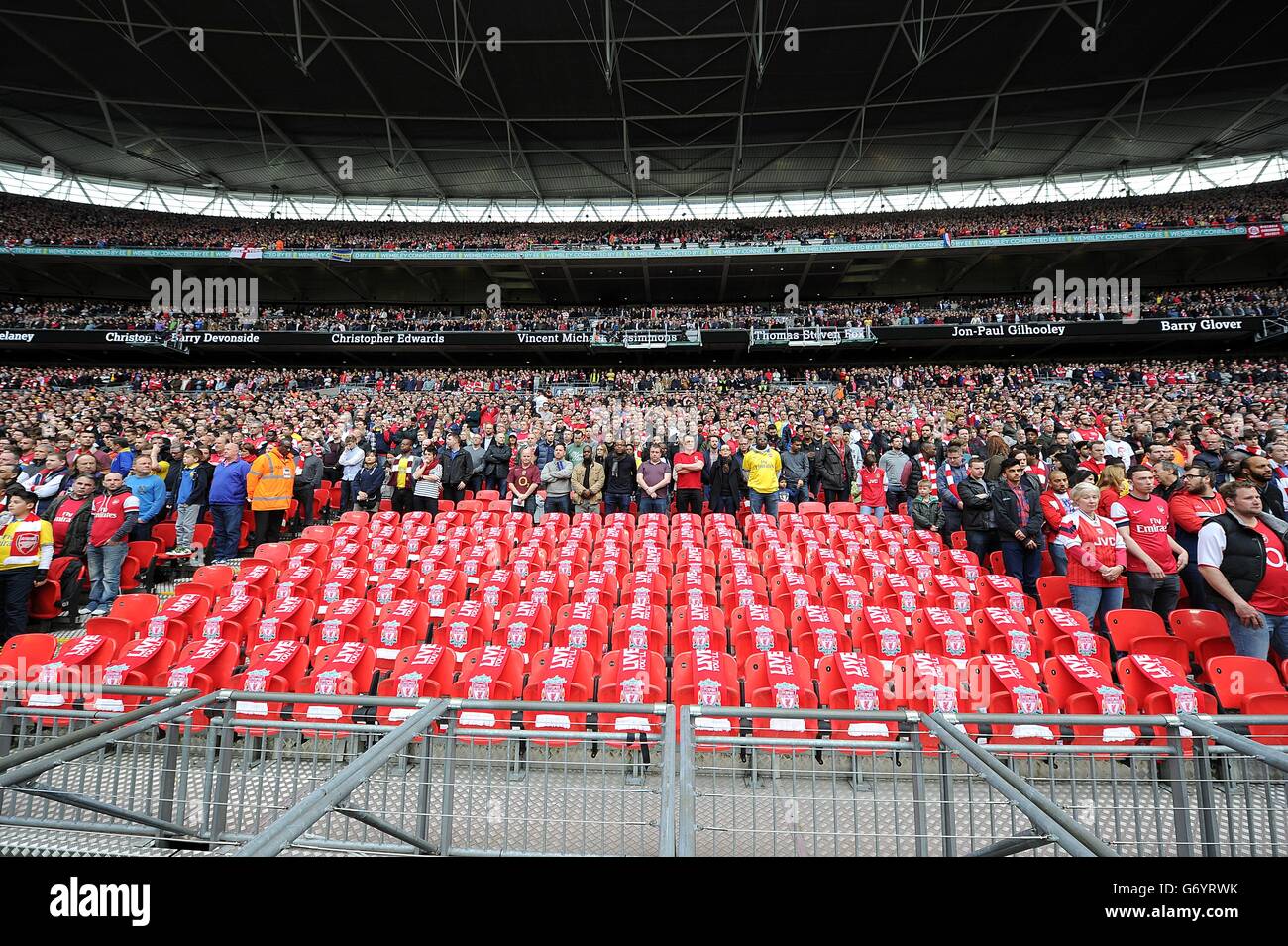 Arsenal fans during a minutes remembrance next to the 96 seats that are ...