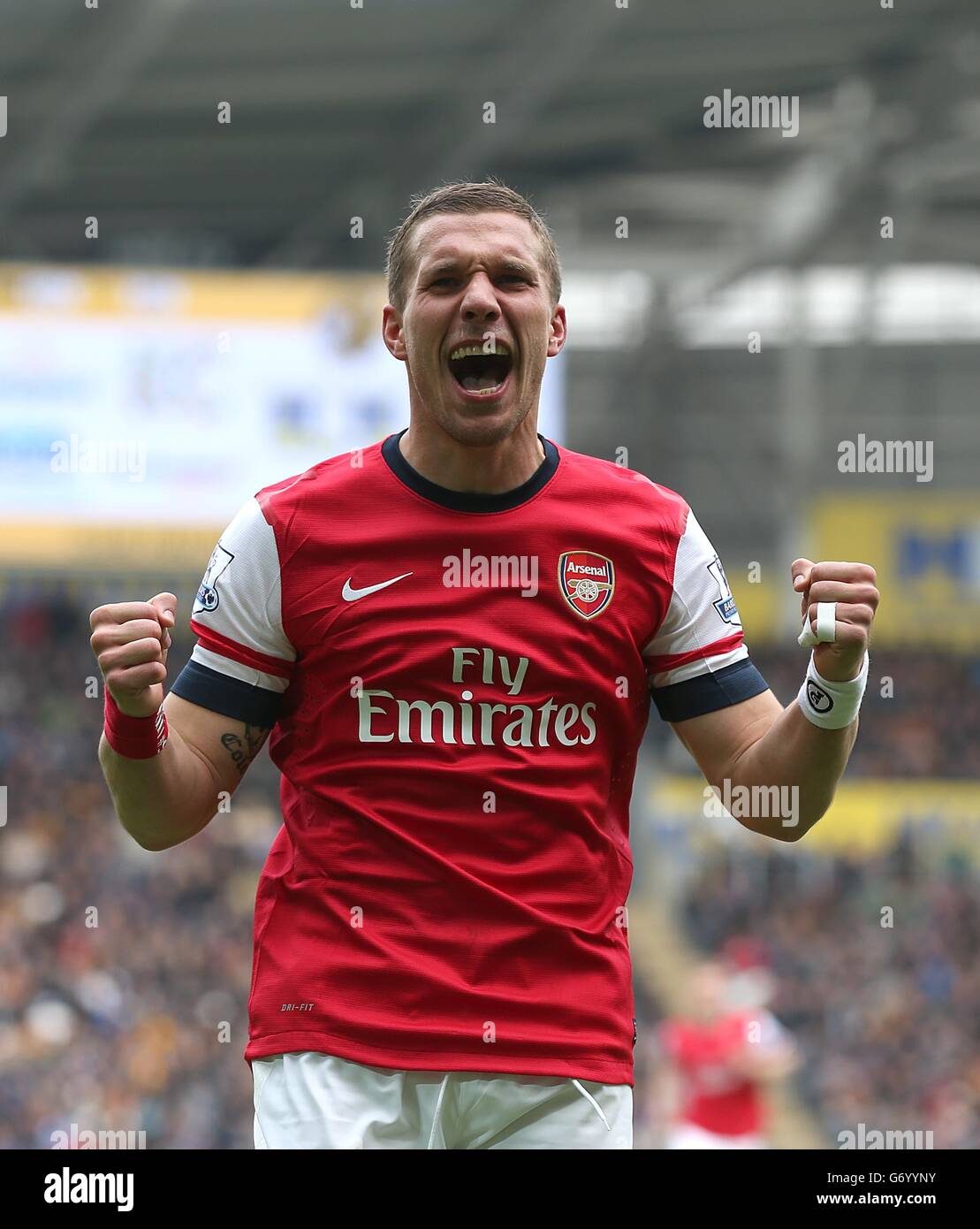 Arsenal's Lukas Podolski celebrates scoring his side's third goal Stock ...