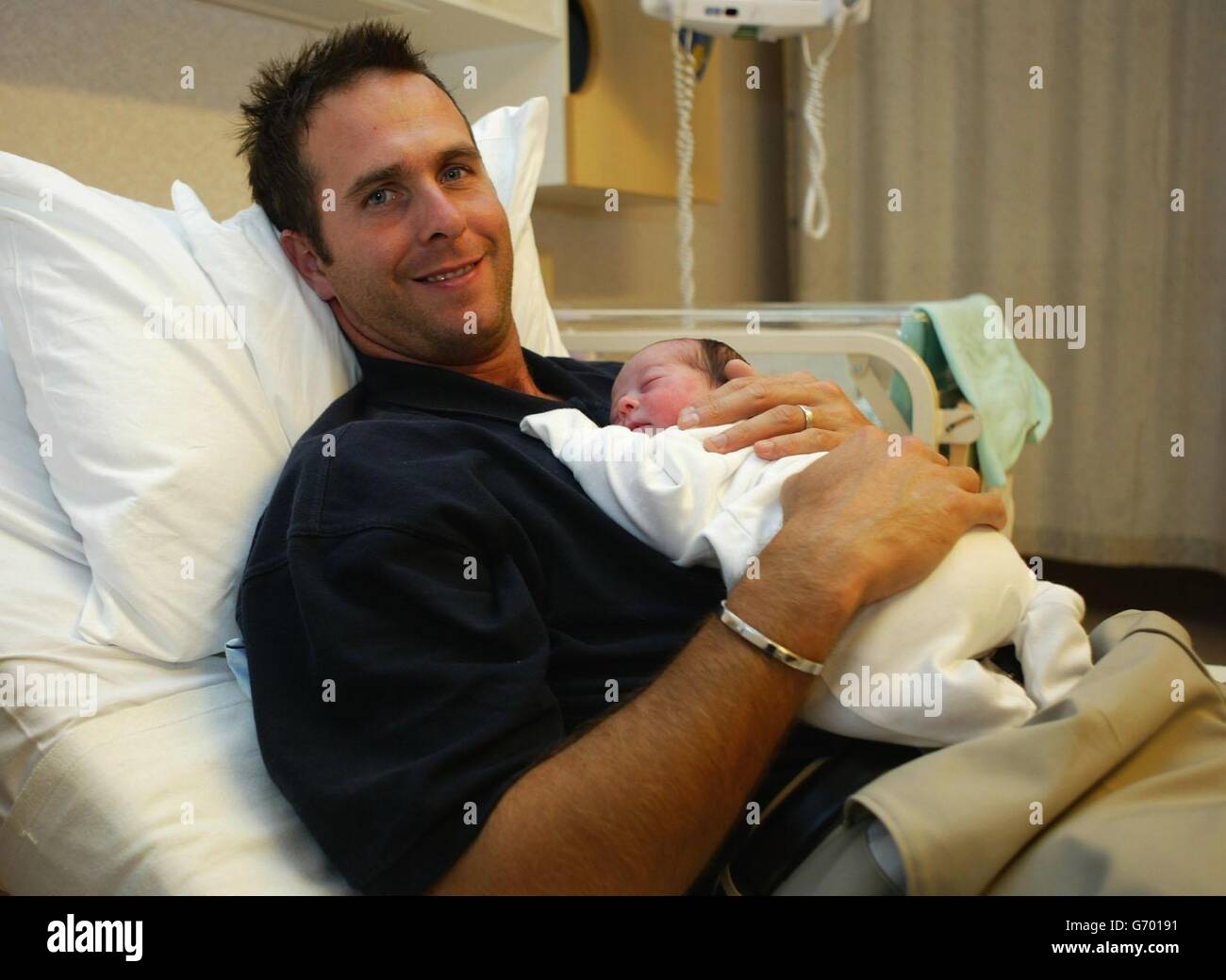 England's Test cricket captain Michael Vaughan with his baby daughter ...