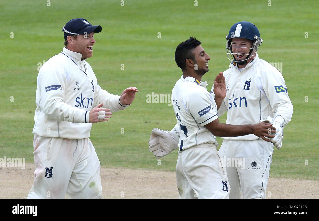Warwickshire's Ateeq Javid (right) celebrates taking the wicket of ...
