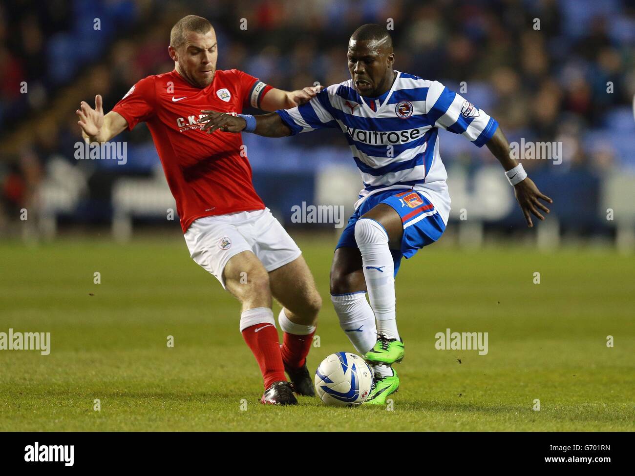 Reading's Royston Drenthe is tackled by Barnsley's Stephen Dawson ...