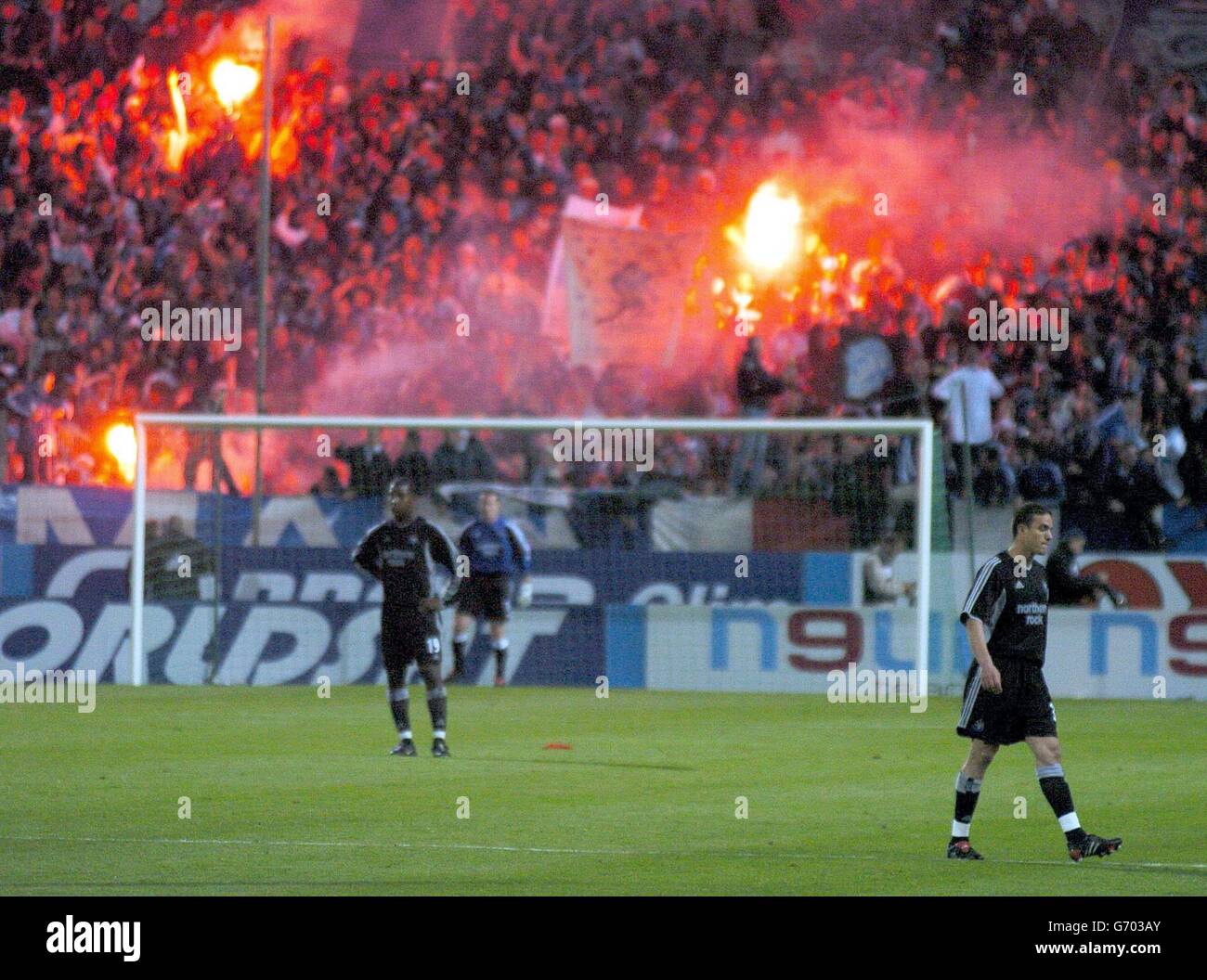 Flares are set off on the terraces behind the Newcastle goal, at the ...